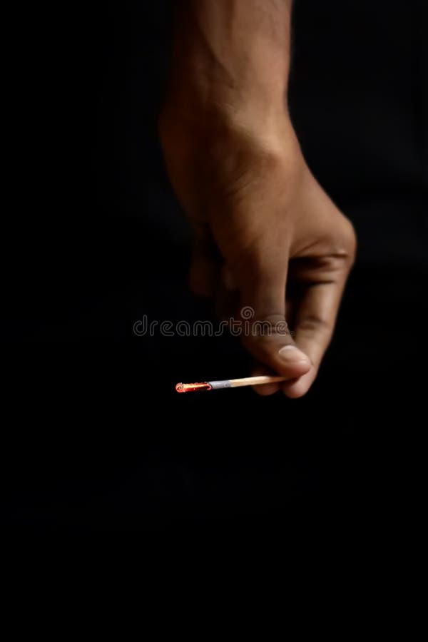 Burnt Extinguished Match Held in Hand on Black Rugged Background. Stock ...