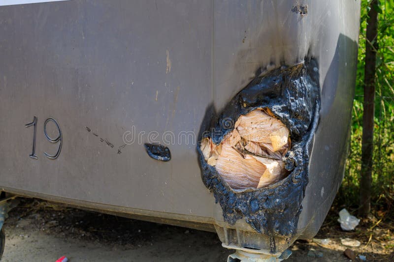 A Burnt Hole in a Plastic Trash Can or Bin. Background with Selective ...