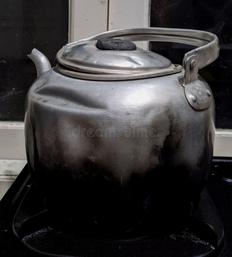 Burnt kettle on the stove stock photo. Image of iron - 268213344