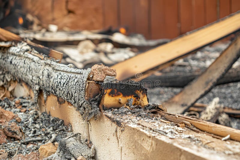A Burnt Log Sits Atop a Pile of Rubble, Offering a Glimpse into Post ...