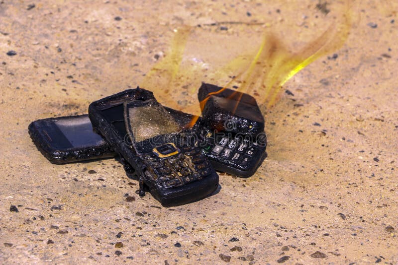 Burnt Mobile Phones on Textural Concrete Background. Concept: Danger of ...