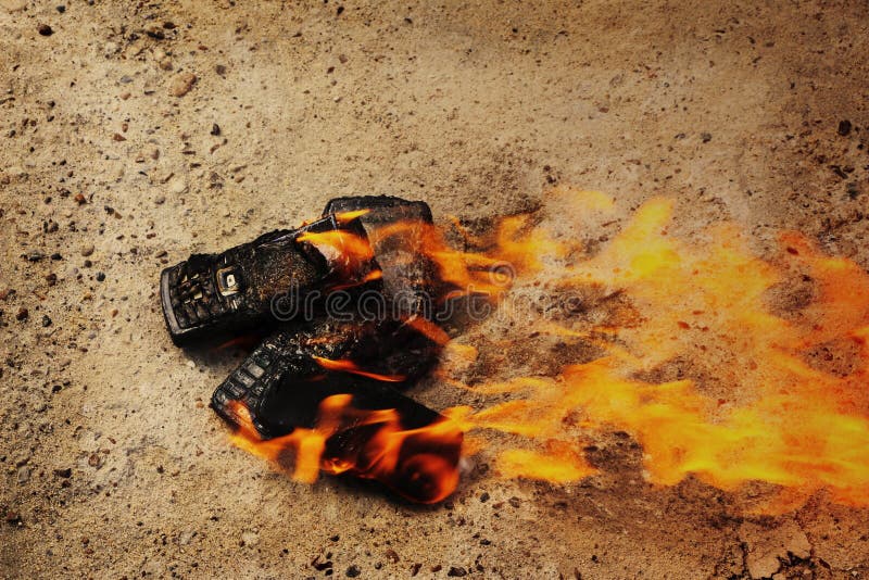 Burnt Mobile Phones on Textural Concrete Background. Concept: Danger of ...