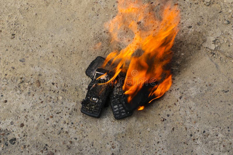 Burnt Mobile Phones on Textural Concrete Background. Concept: Danger of ...