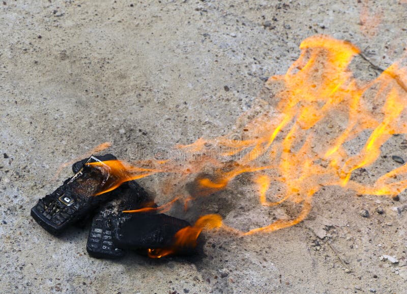 Burnt Mobile Phones on Textural Concrete Background. Concept: Danger of ...