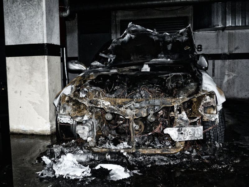 Burnt Out Car in an Underground Garage. Charred Melted Metal Parts and ...