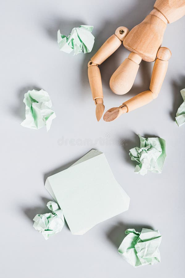 Burnt Out Man among Crumpled Note Papers on Desk Top and Vertical View ...