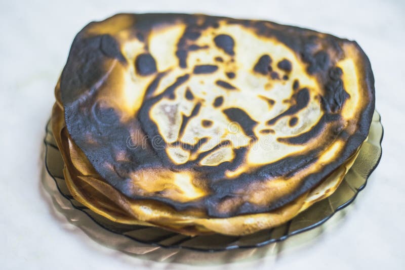 Burnt pancake on the table stock image. Image of indoors - 185082439