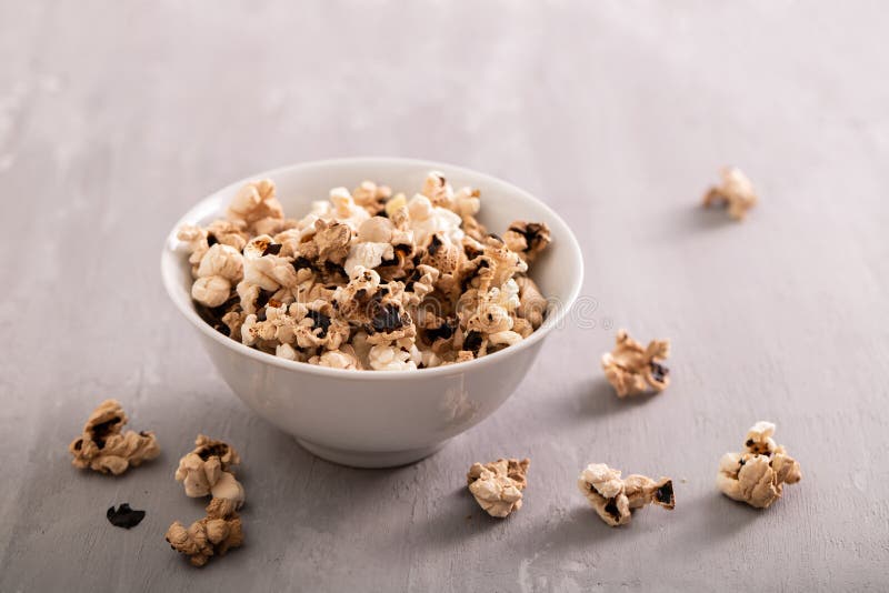Burnt Popcorn in the Small White Bowl on Ceramic Stock Photo - Image of ...