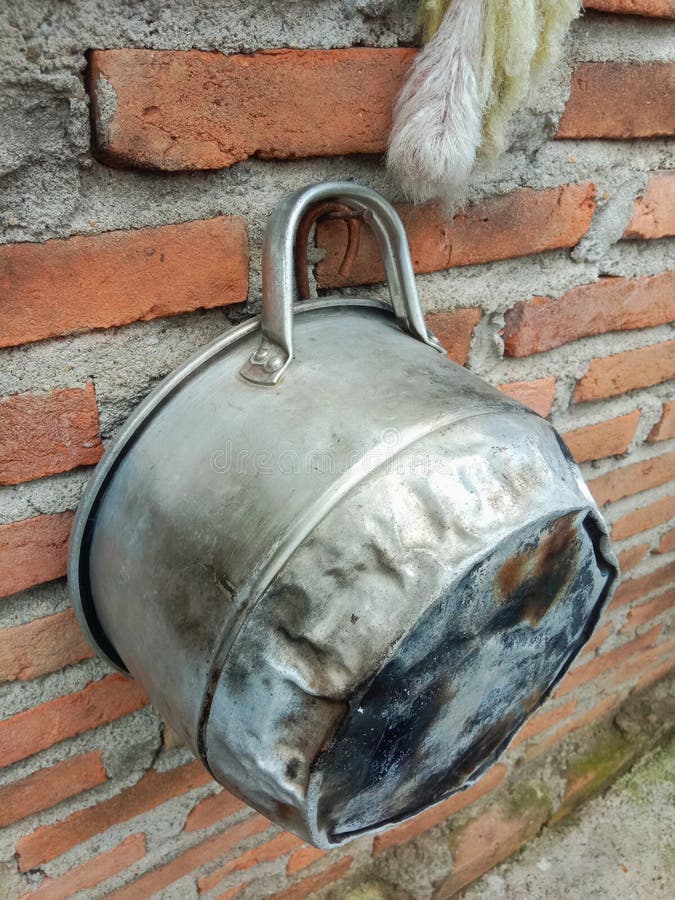 A Burnt Pot Hanging from a Red Brick Wall Stock Image - Image of burnt ...