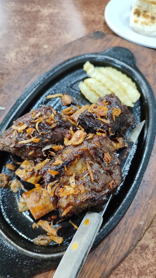 Burnt steak grilled ribs stock image. Image of igabakar - 331978585