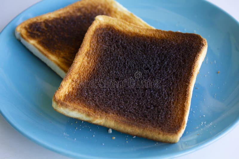Burnt toast bread on plate stock photo. Image of lunch - 213579046