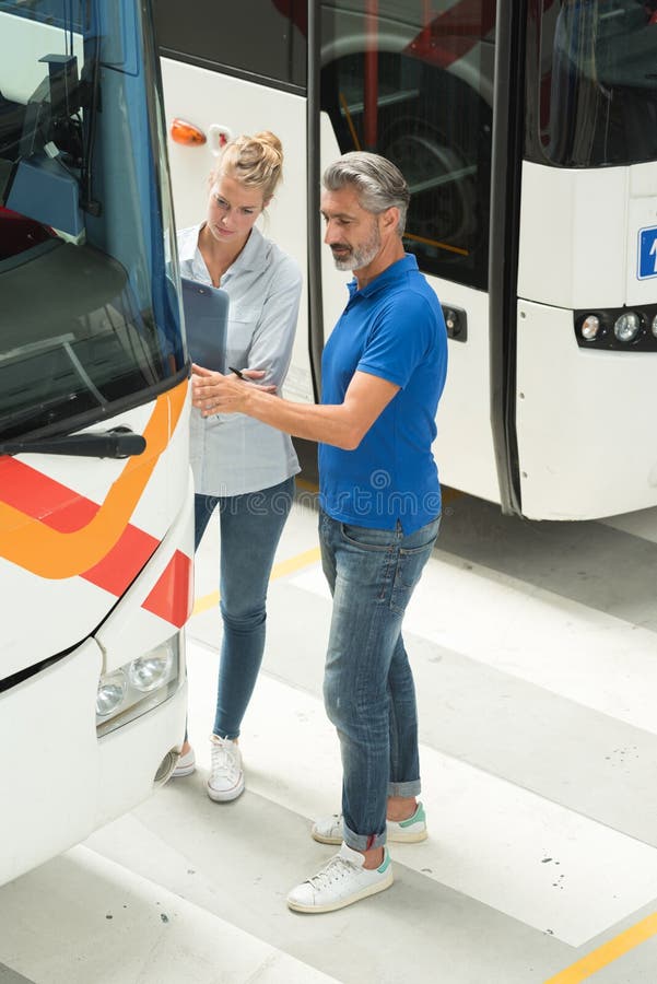 Bus Company Workers Looking at Bus Stock Image - Image of shop ...
