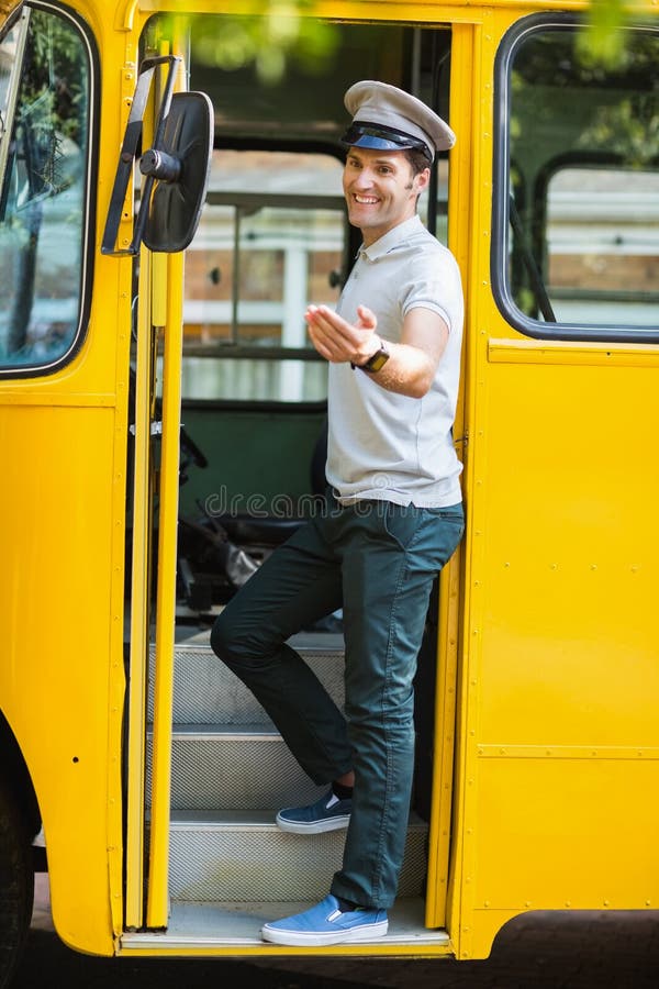 Bus Driver Standing at the Entrance of Bus and Gesturing Stock Photo ...