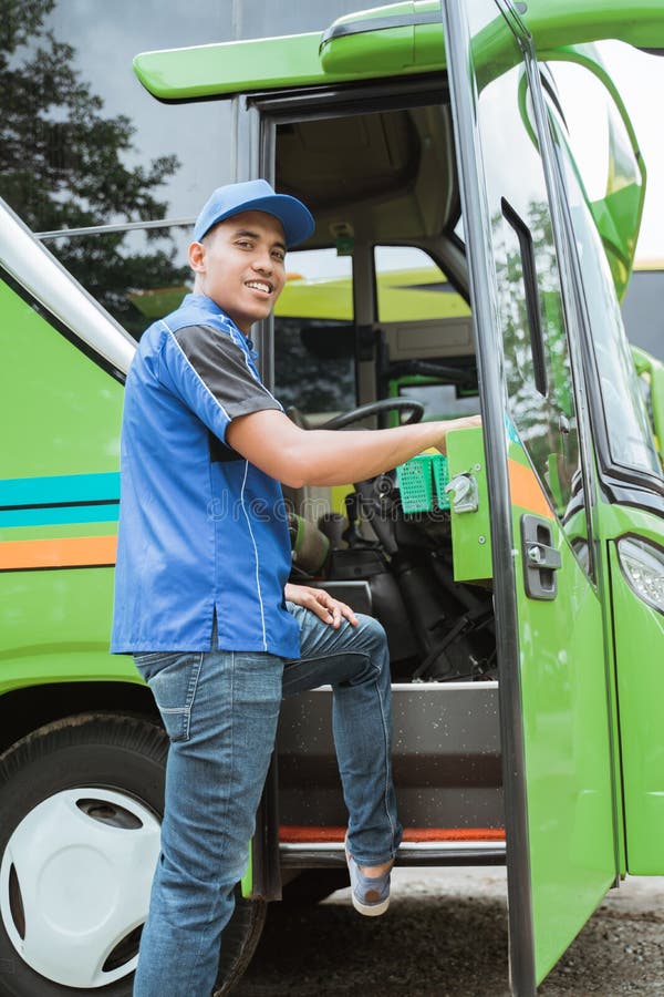 A Bus Driver in a Uniform and a Hat Opened the Bus Door Stock Image ...