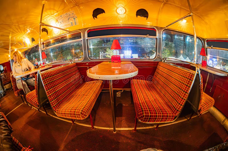 Bus Interior Transformed into a Restaurant with Plaid Seating and ...