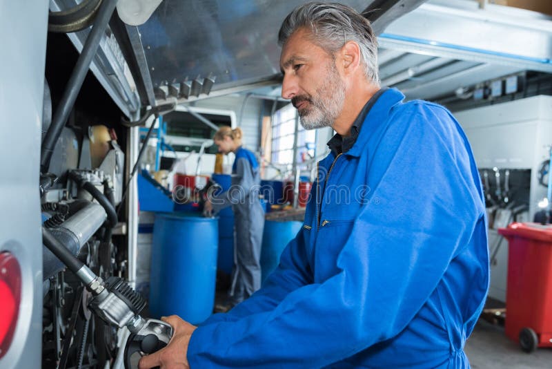 Bus mechanic at work stock photo. Image of base, water - 268033884
