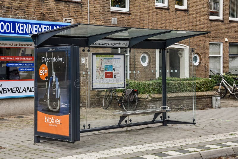 A Bus Stop with a Bench Next To a Bus Editorial Stock Image - Image of ...