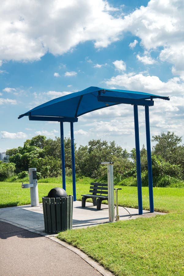Bus Stop with a Canopy and a Drinker. Green Lawn and Blue Sky Stock ...