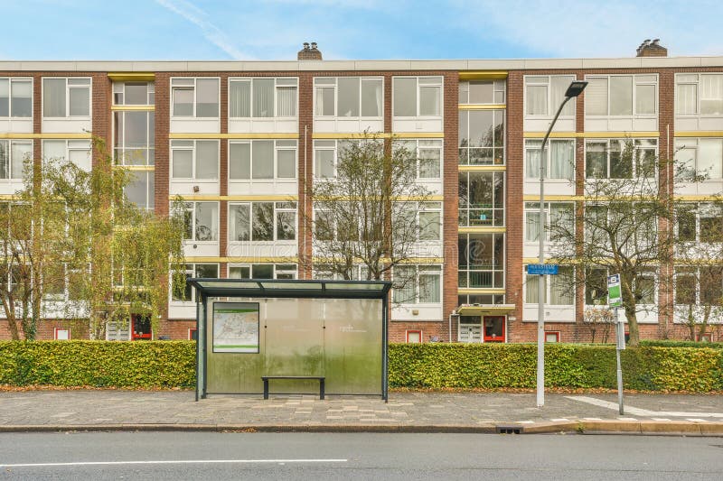 A Bus Stop in Front of an Apartment Building Editorial Photo - Image of ...