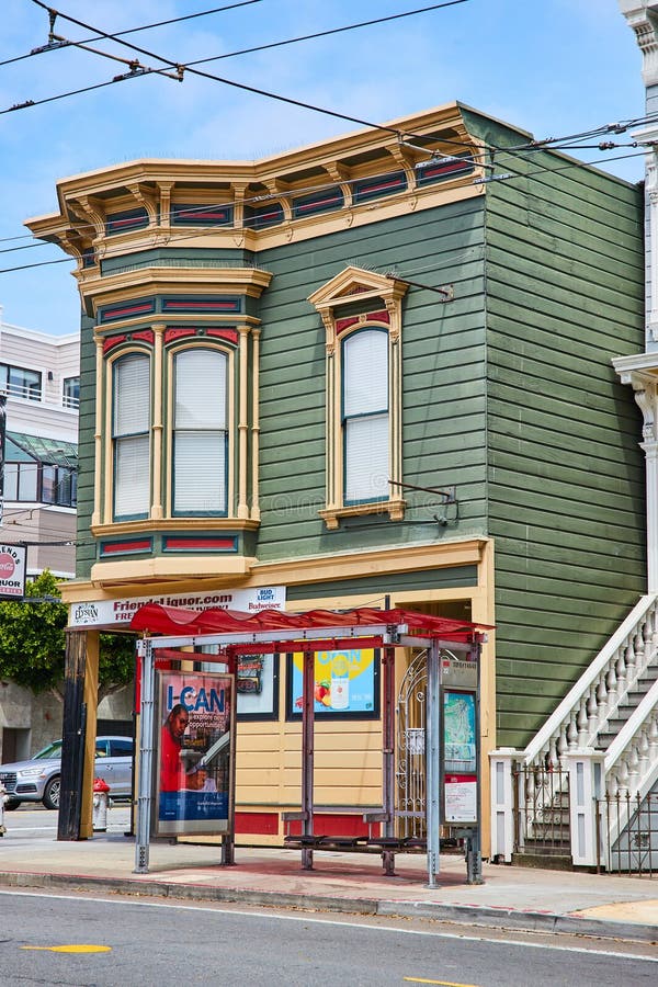 Bus Stop in Front of Green House with Bay Windows and White Staircase ...