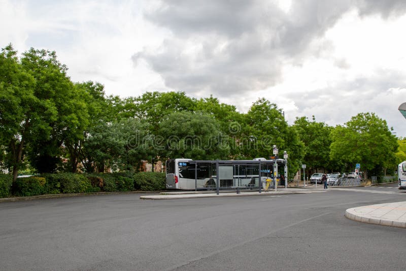 Bus Stop with Bus, Trees, and Cloudy Sky Editorial Stock Image - Image ...