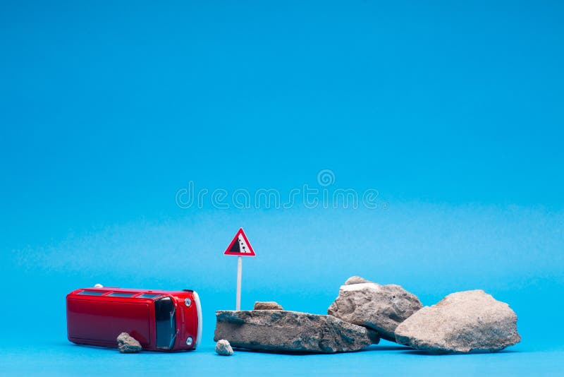 A Bus Turned Over before a Huge Stone and a Cliff Sign, on Blue ...