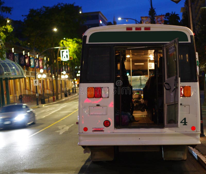 People Waiting For The Bus At The Bus Stop. View From The Back. Stock ...