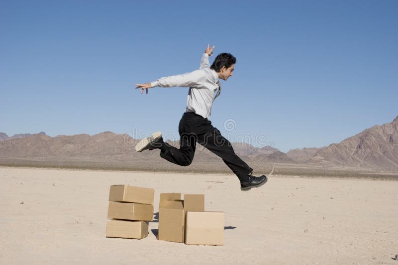 Businesman Jumping Over Boxes Stock Image - Image of businessman ...