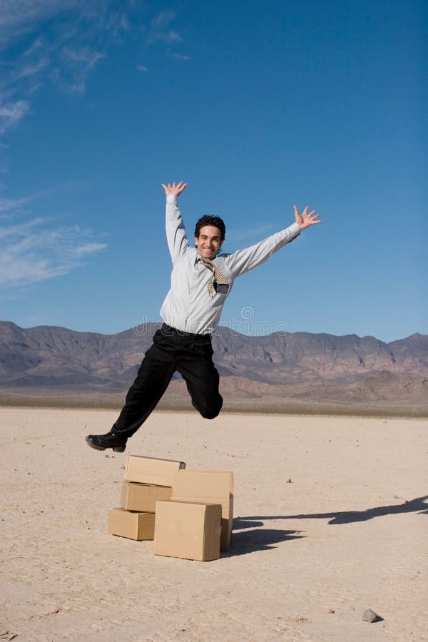 Businesman Jumping Over Boxes Stock Photo - Image of outdoors, jump ...