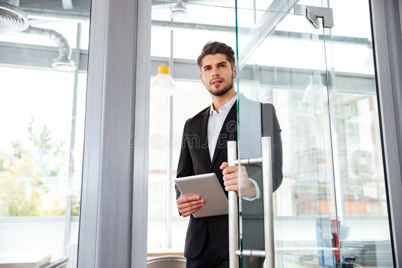Businesman with Tablet Entering the Door in Office Stock Image - Image ...