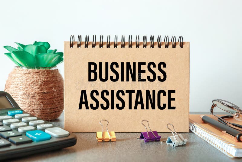 BUSINESS ASSISTANCE is Written on a Notepad on an Office Desk Stock ...
