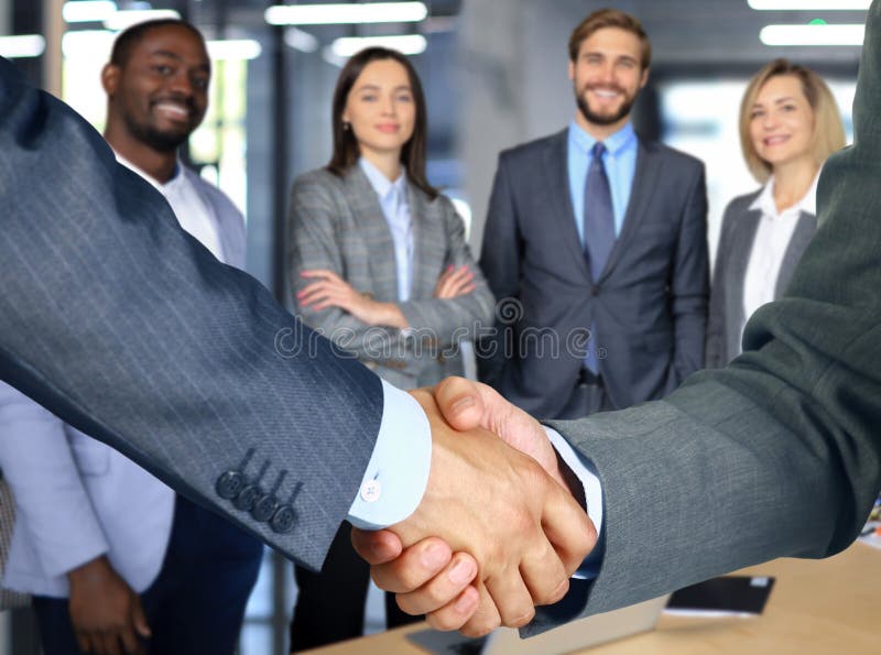 Business Associates Shaking Hands in Office. Stock Image - Image of ...