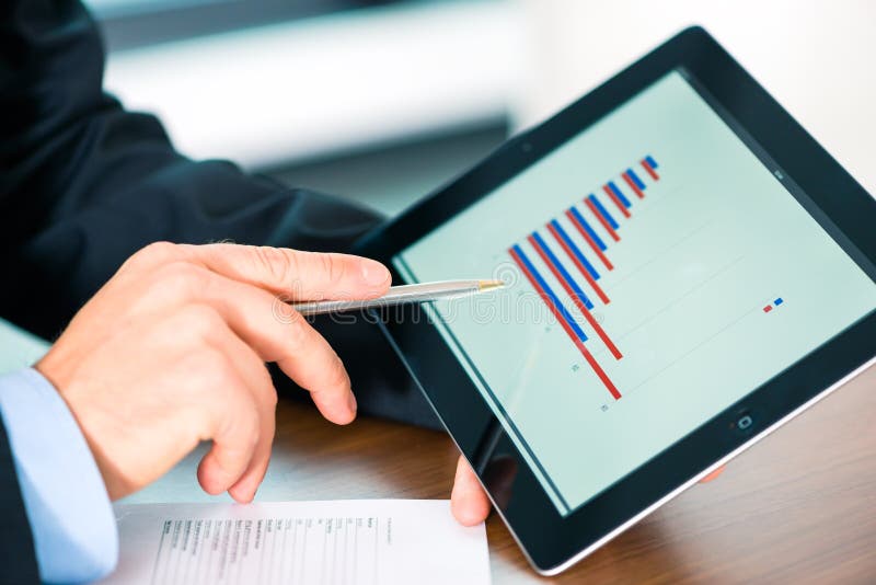 Business Man Working and Analyzing Financial Figures on a Graphs on a ...