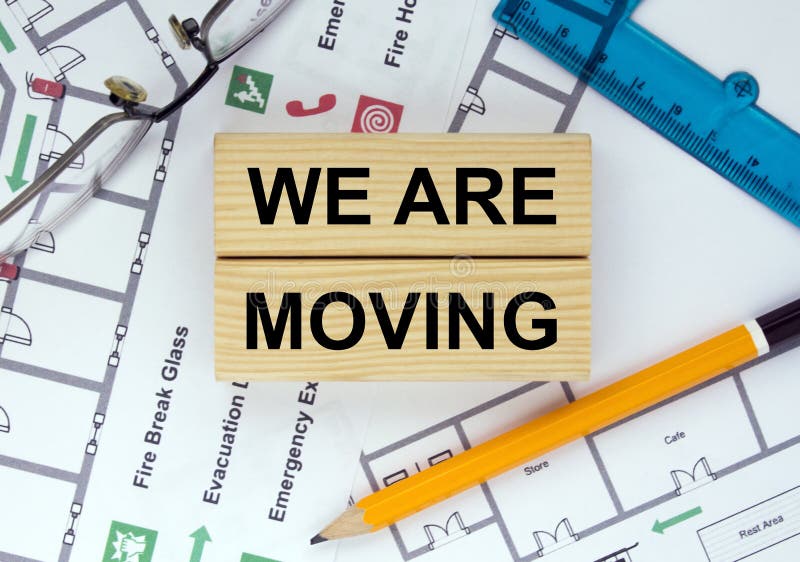 Wooden Blocks with Text we are Moving on a Construction Drawing Stock ...