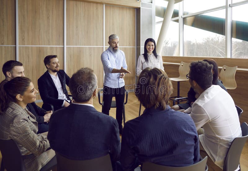 Business Coach Meeting With Team Of People Sharing Expertise And