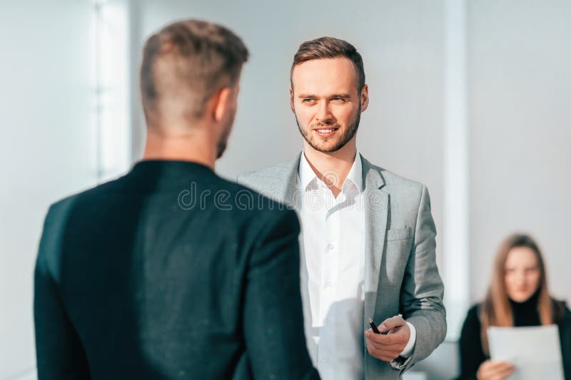 Business Colleagues Discuss Something Standing in the Office Stock ...