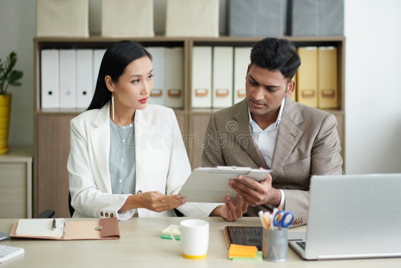 Business Colleagues Discussing Document Stock Image - Image of ...