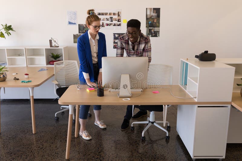 Business Colleagues Discussing Over Personal Computer in Office Stock ...