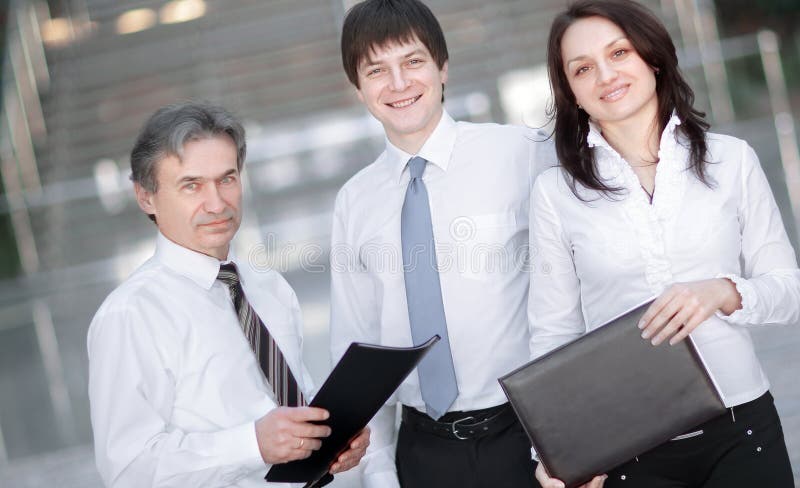 Business Colleagues Discussing Working Papers Standing in a Modern ...