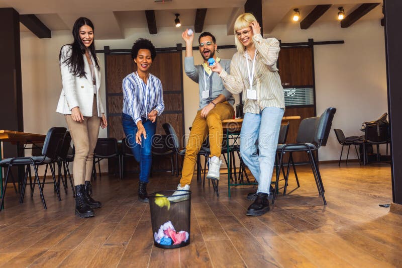 Business Colleagues Having Fun at the Office, Playing Trash Can ...