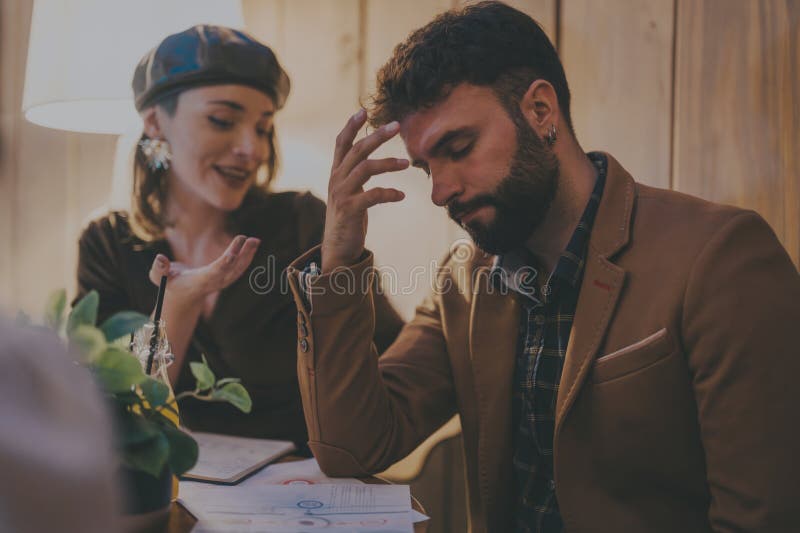 Business Colleagues Having a Serious Discussion Over a Project Plan ...