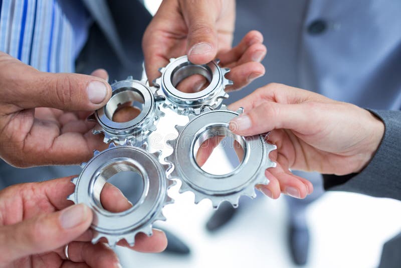 Business Colleagues Holding Cog Stock Image - Image of four, coworkers ...