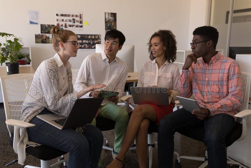 Business Colleagues Interacting with Each Other in Office Stock Photo ...