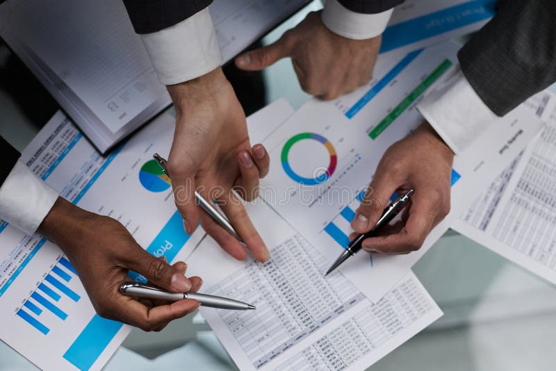 Business Colleagues Look at the Graph on the Table from Above Stock ...