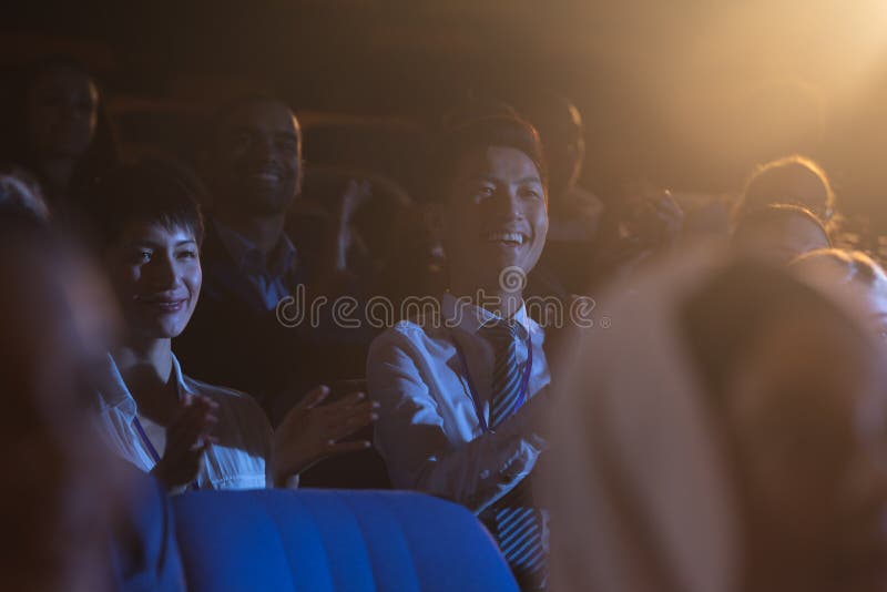 Business Colleagues Sitting and Watching Presentation with Audience ...