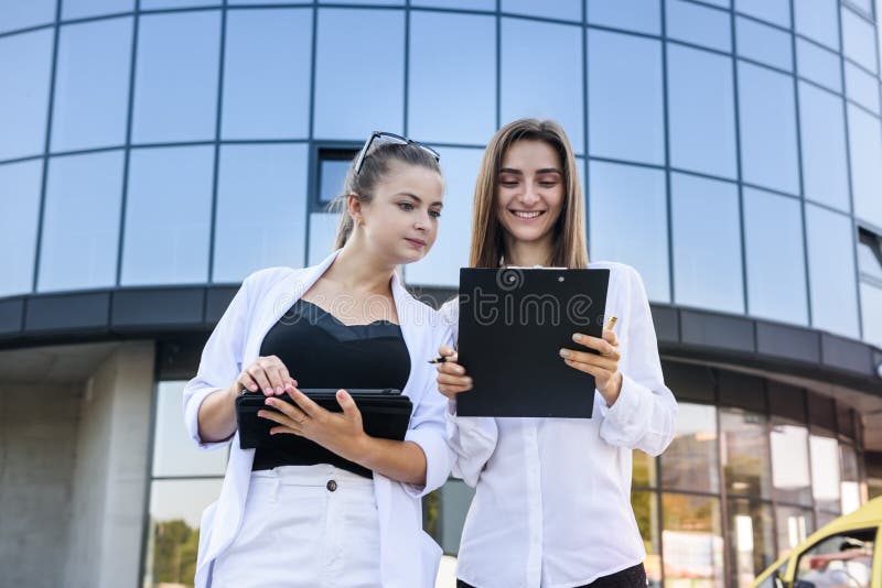 Business Colleagues Standing before Big Office Center with Tablet and ...