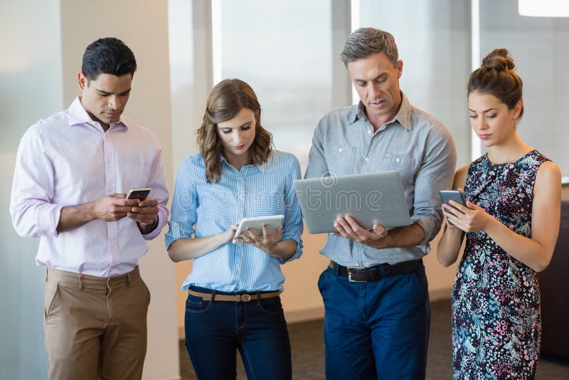 Business Colleagues Using Mobile Phone, Digital Tablet and Laptop Stock ...