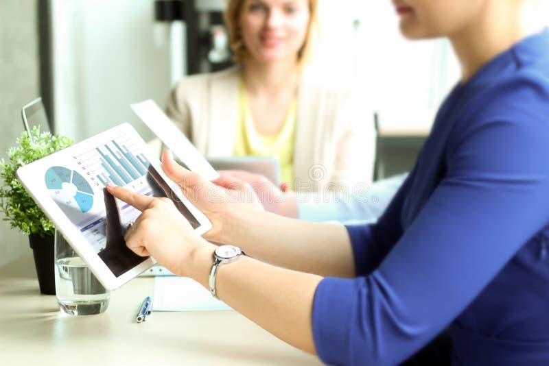 Business Colleagues Working and Analyzing Financial Figures on a Graphs ...