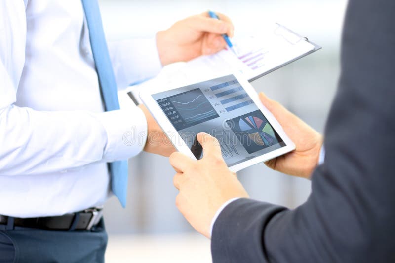 Business Colleagues Working and Analyzing Financial Figures / Graphs on ...
