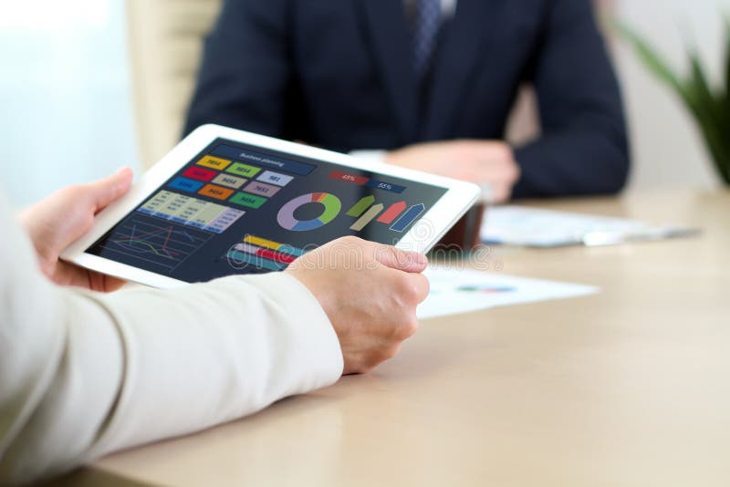 Business Colleagues Working and Analyzing Financial Figures / Graphs on ...